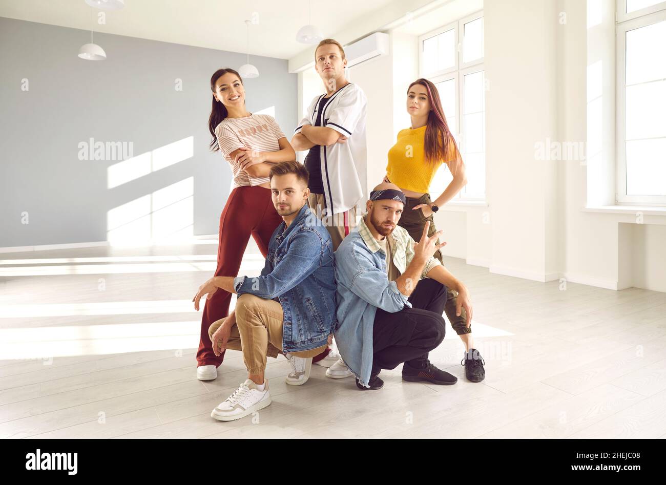 Group portrait of dancing crew pose in studio Stock Photo - Alamy