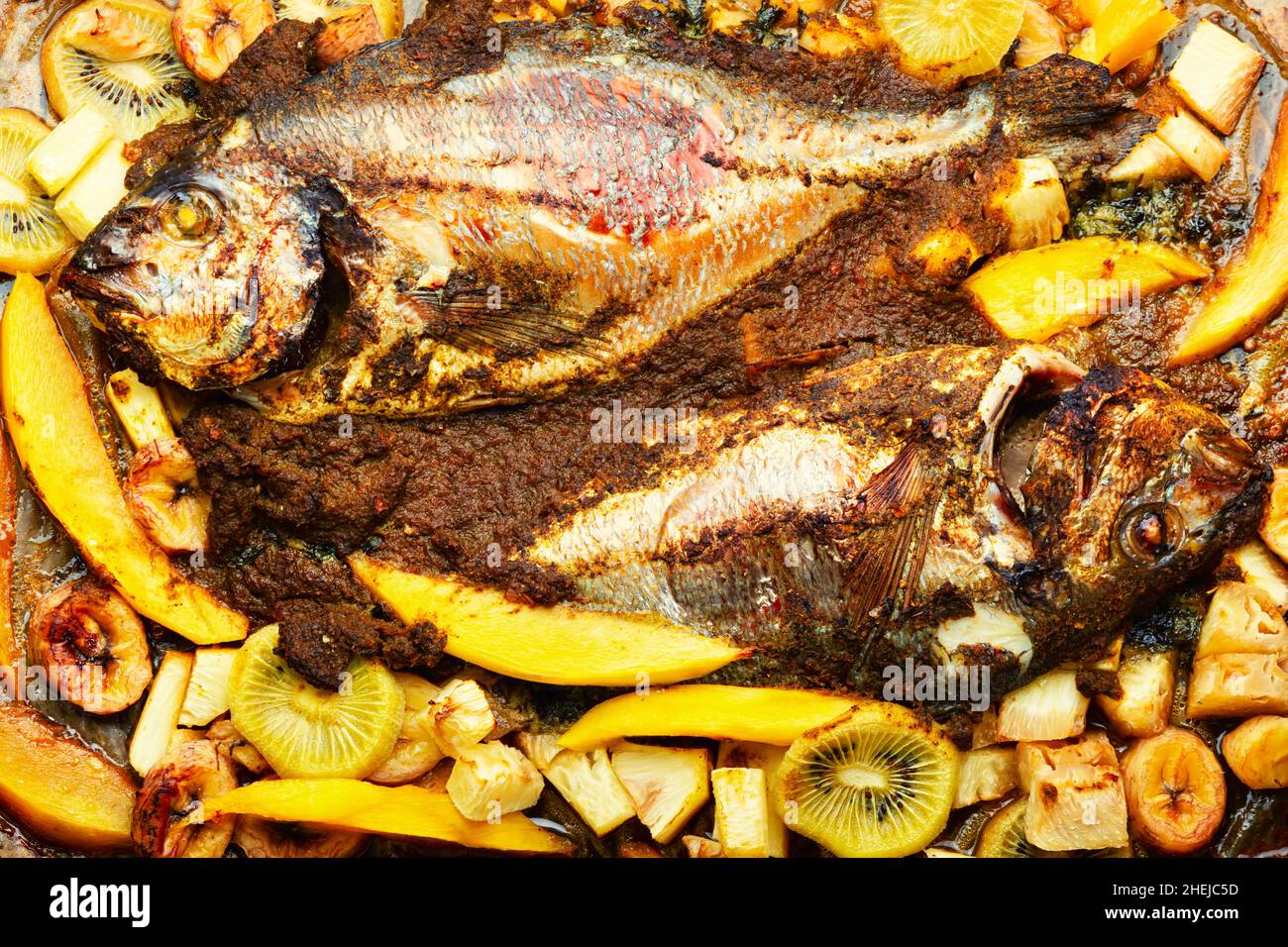 Delicious fried fish dorada with fruits and spices Stock Photo - Alamy