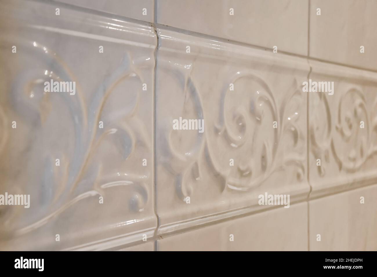 Wonderful pattern on white marble tiles on the wall Stock Photo - Alamy