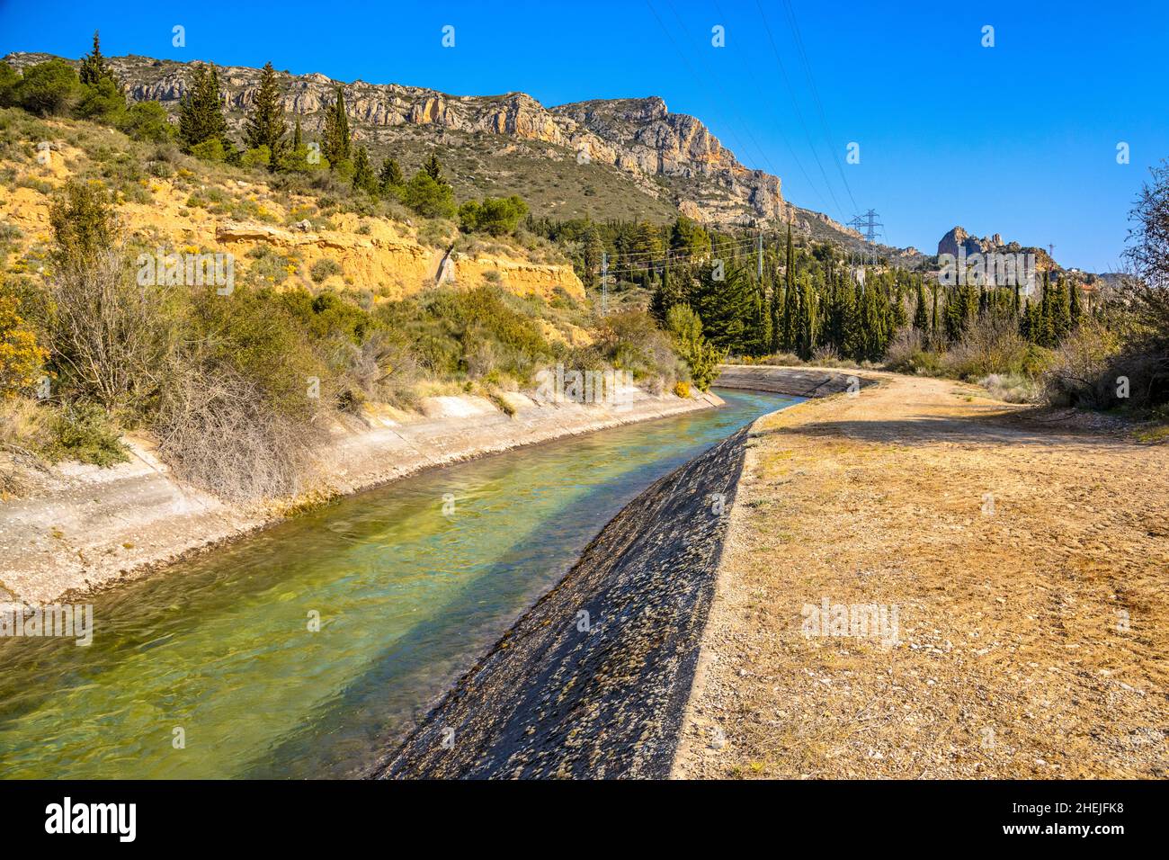 Irrigation canal at Embalse de Santa Ana reservoir lake in Sierras ...