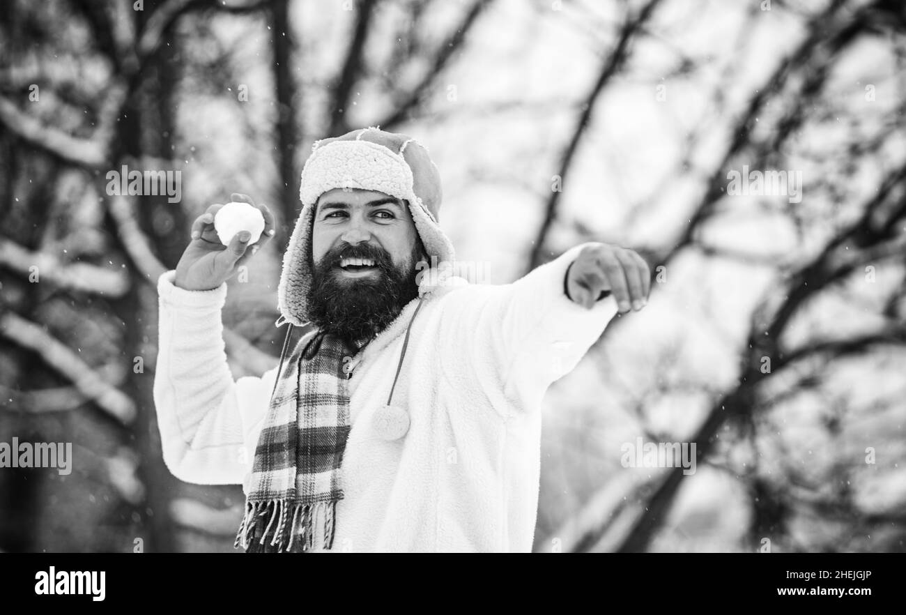 Christmas preparation - man with snowball. Winter scene on white snow ...
