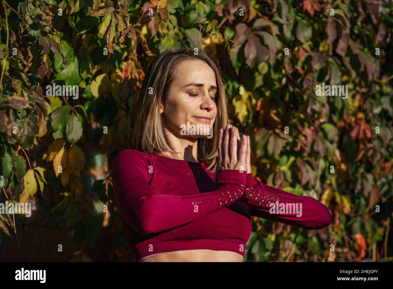Namaste, beautiful girl in sportswear doing yoga poses on the alley in ...