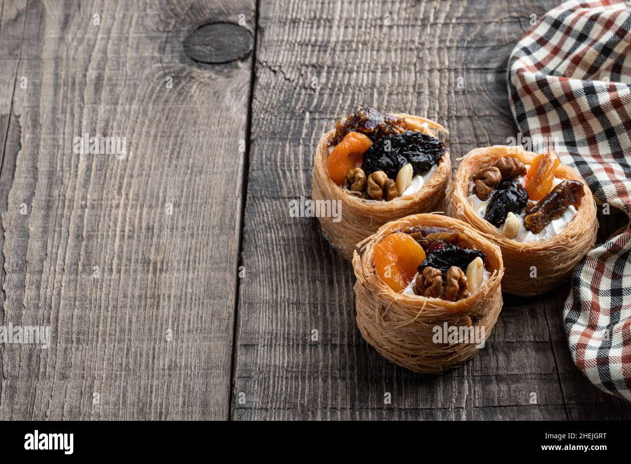 Traditional arabic and turkish sweets pastry dessert kadaif with nuts ...