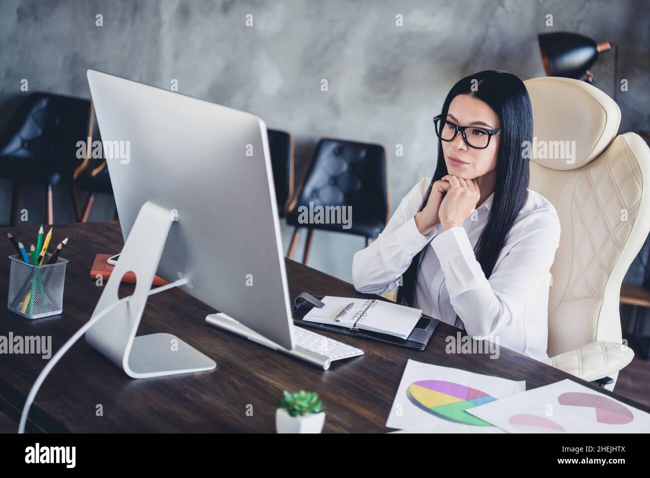 Portrait of concentrated serious clever lady sitting chair look ...