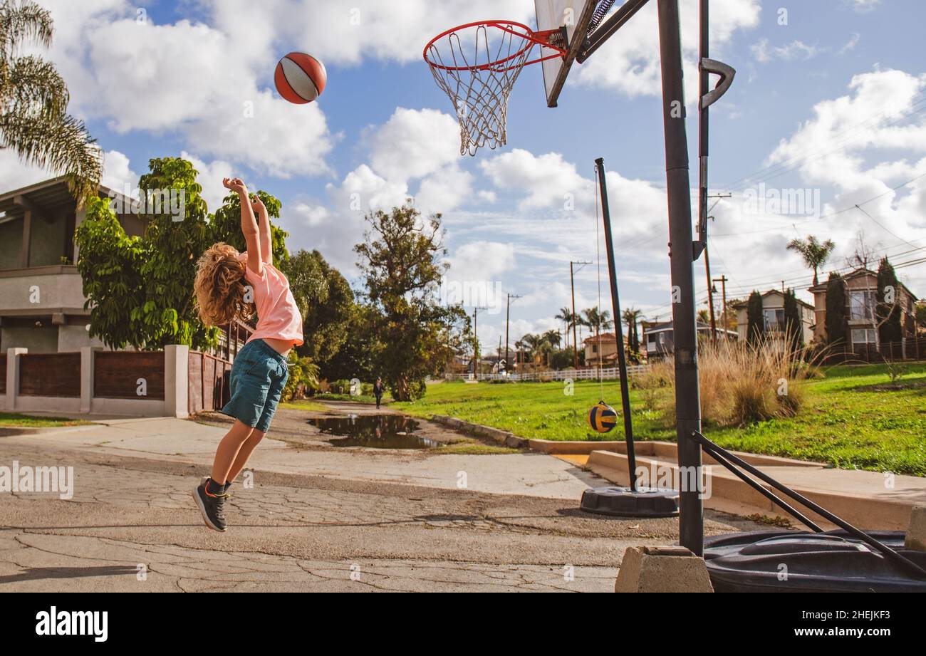 Cute little boy child jumping with basket ball for shot. Sport for kids ...