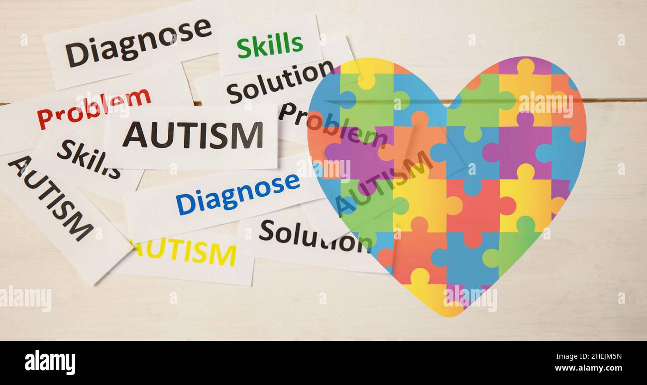 Image of autism text over heart formed with autism awareness puzzles on ...