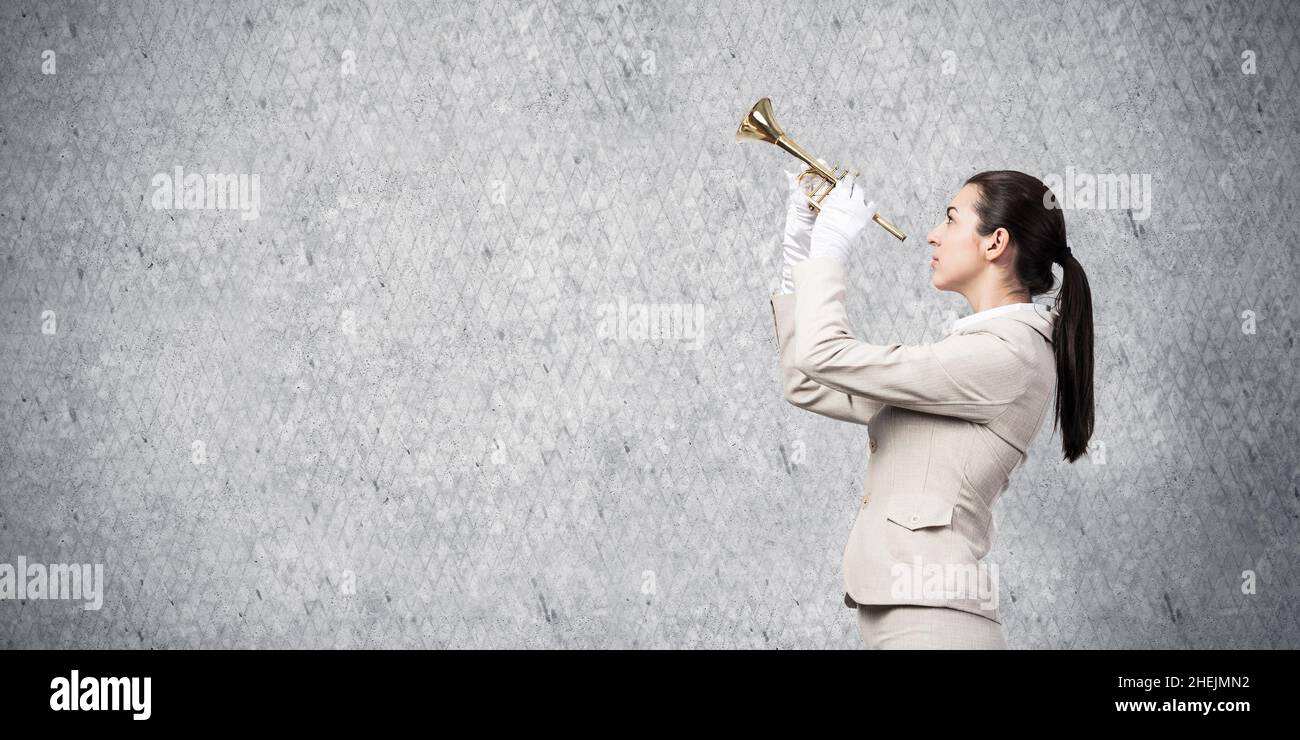 Beautiful woman playing trumpet brass Stock Photo - Alamy