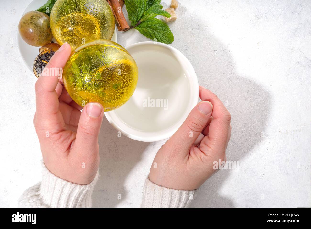 Making tea with Trendy modern tea ball bombs. Tea balls with dried tea ...