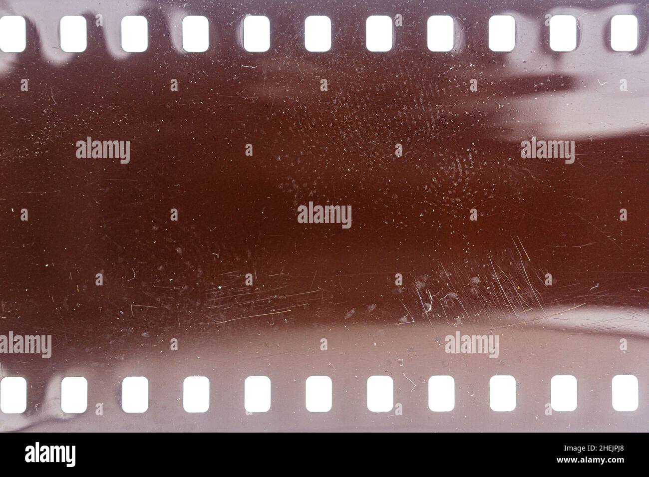 Dusty and grungy 35mm film texture or surface. Perforated scratched ...