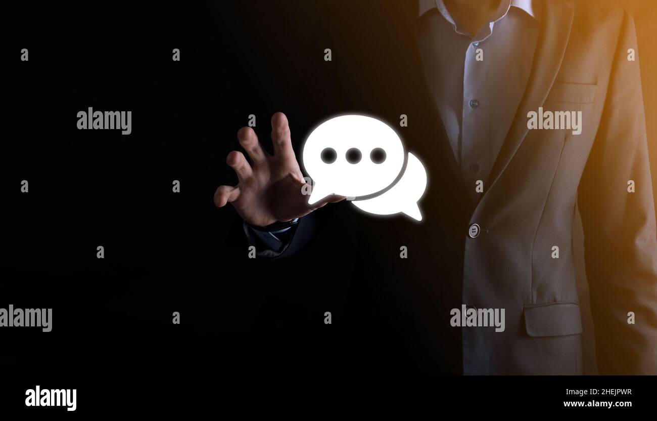 Businessman holding a message icon, bubble talk notification sign in ...