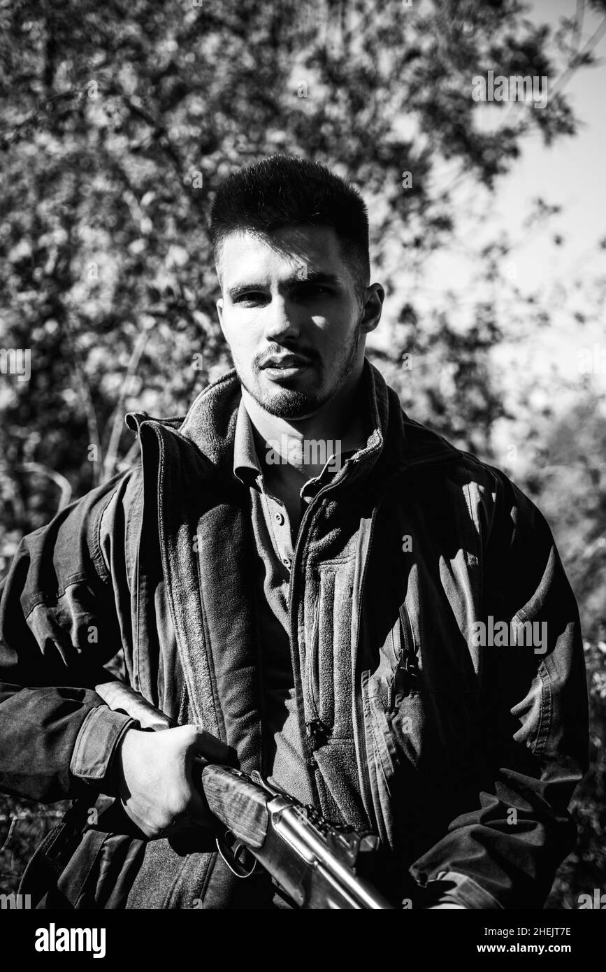 Hunter with shotgun gun on hunt. Close up Portrait of hamdsome Hunter ...