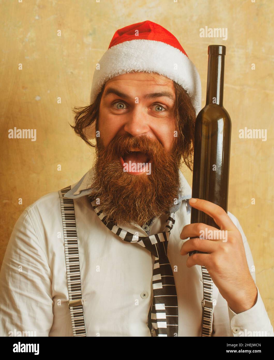 Bad drunk santa. Funny Santa Claus with a bottle of wine enjoying a ...