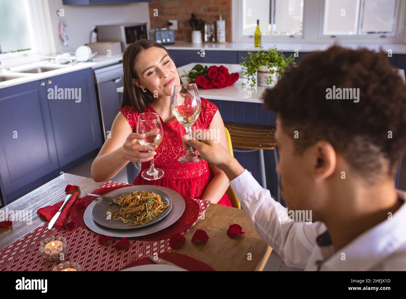 Happy Young Biracial Couple Toasting Drinks While Enjoying Lunch Date