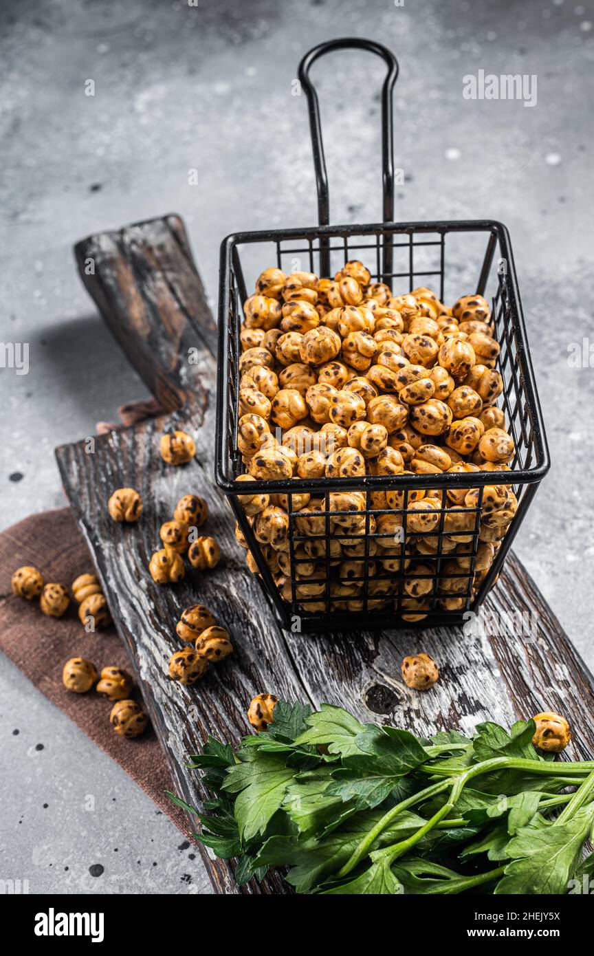 Healthy snack roasted spicy chickpeas in a basket. Gray background. Top ...