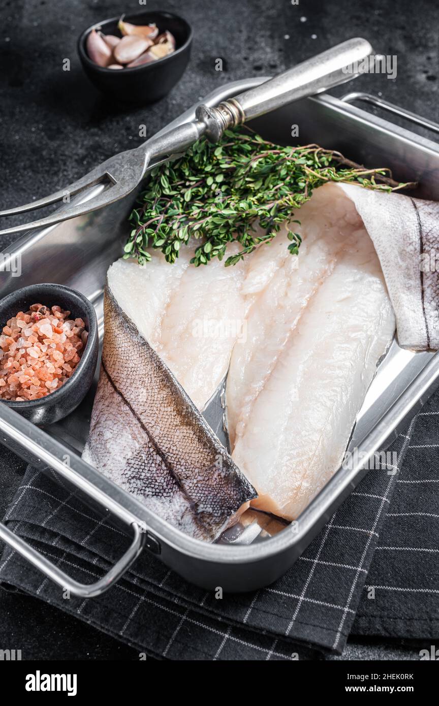 Raw haddock fish fillets, whitefish meat in kitchen tray with thyme ...