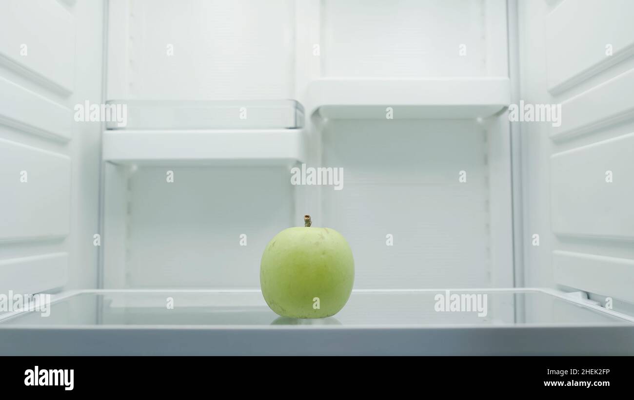 whole fresh apple on shelf in empty refrigerator Stock Photo - Alamy