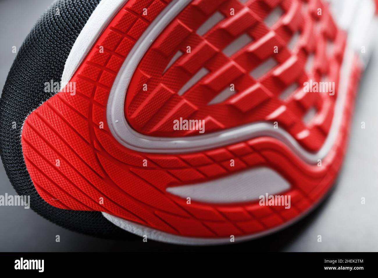 Running shoes with red soles on a black background. Close-up, top view ...