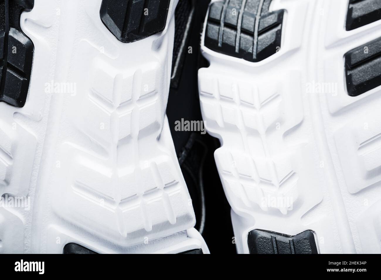 The black and white sole of trendy sports sneakers is a close-up in ...