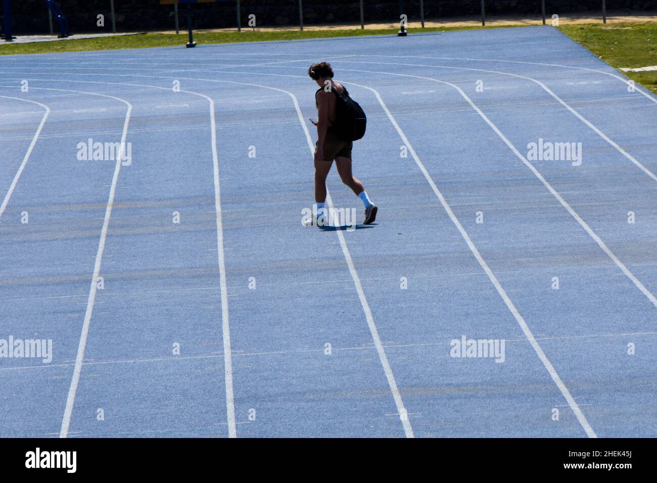Teenager walking on the running track Stock Photo - Alamy