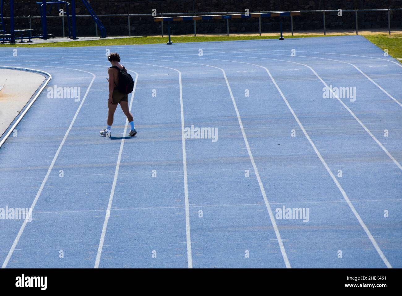 Teenager walking on the running track Stock Photo - Alamy