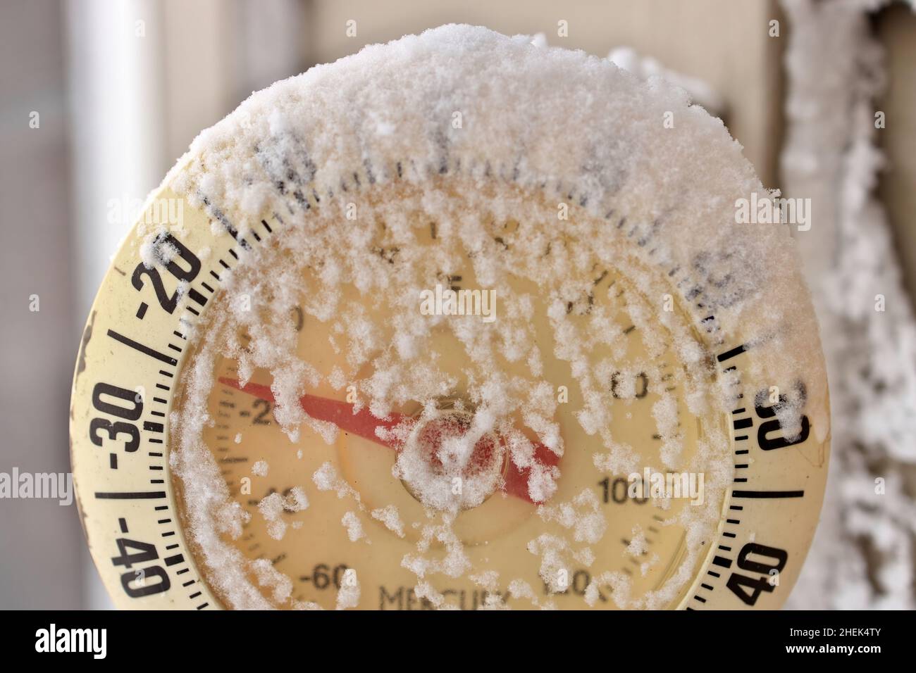 Frosty snow-capped outdoor Thermometer on a extremely cold, frigid ...