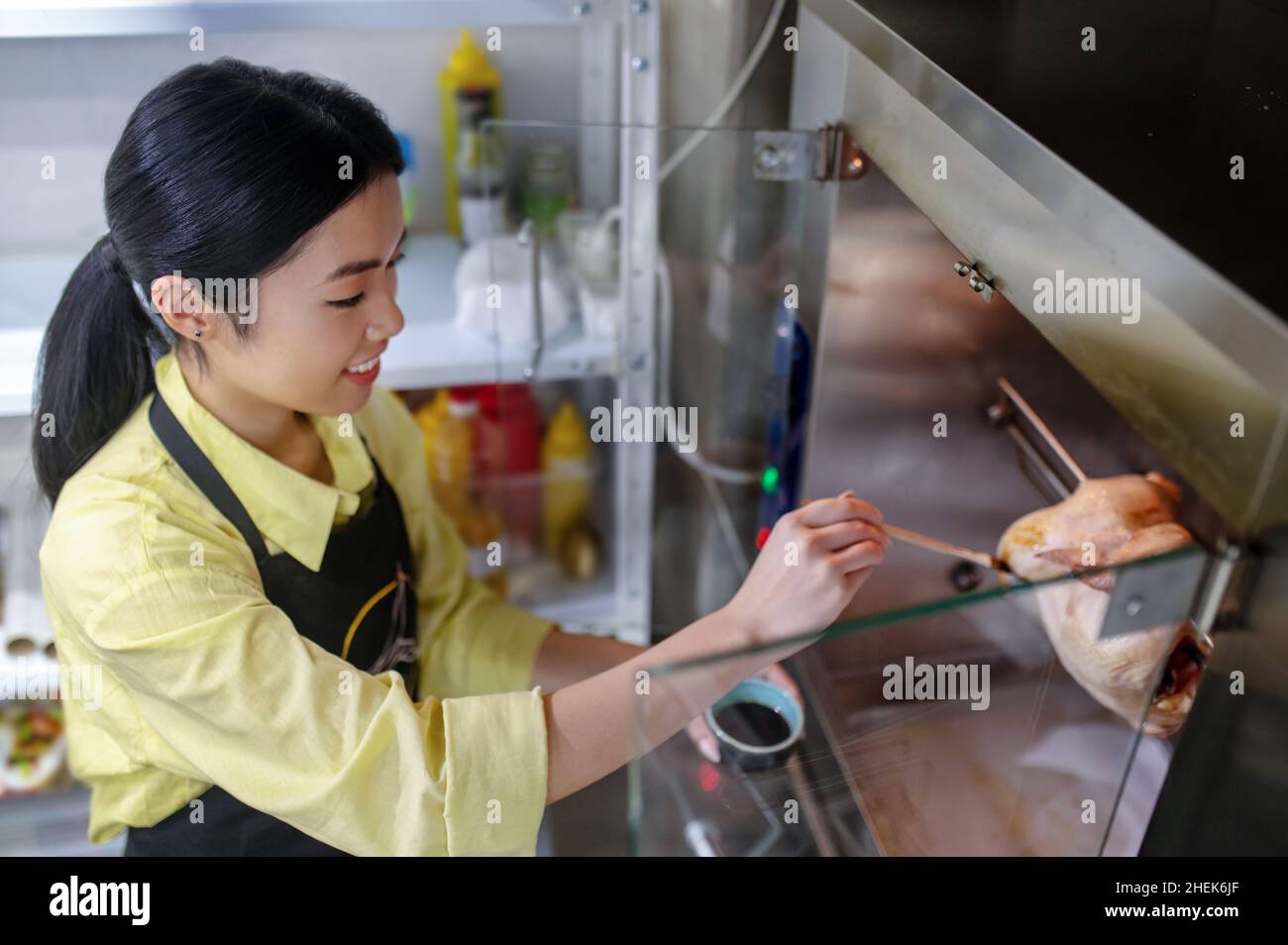 Asian young girl working in the kitchen and preparing food Stock Photo ...