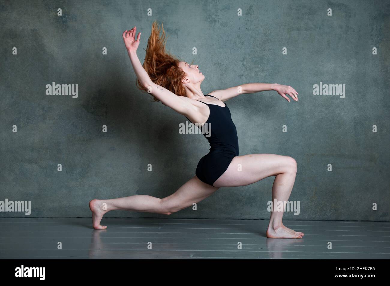 Petitie dancer with flowing red auburn hair dancing in black shorts and ...
