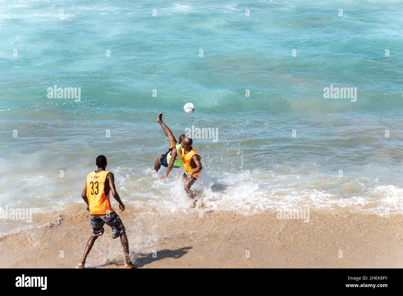 People playing sand football at Farol da Barra beachfront in Salvador ...