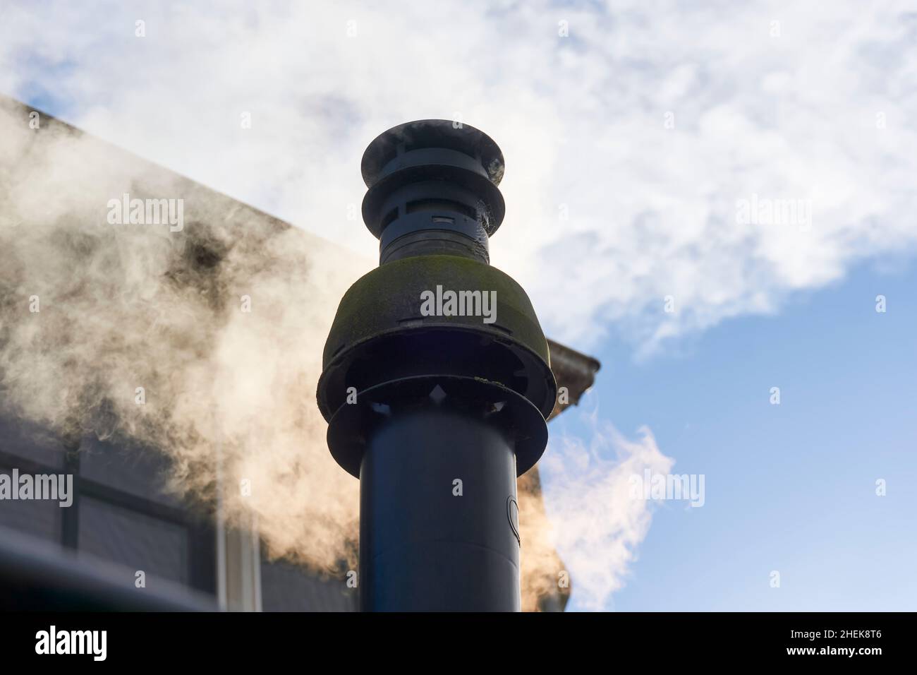 Modern plastic chimney with smoke from natural gas heating in winter ...