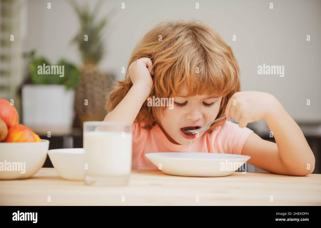Closeup face of kid eating organic food, yogurt, milk. Child healthy ...