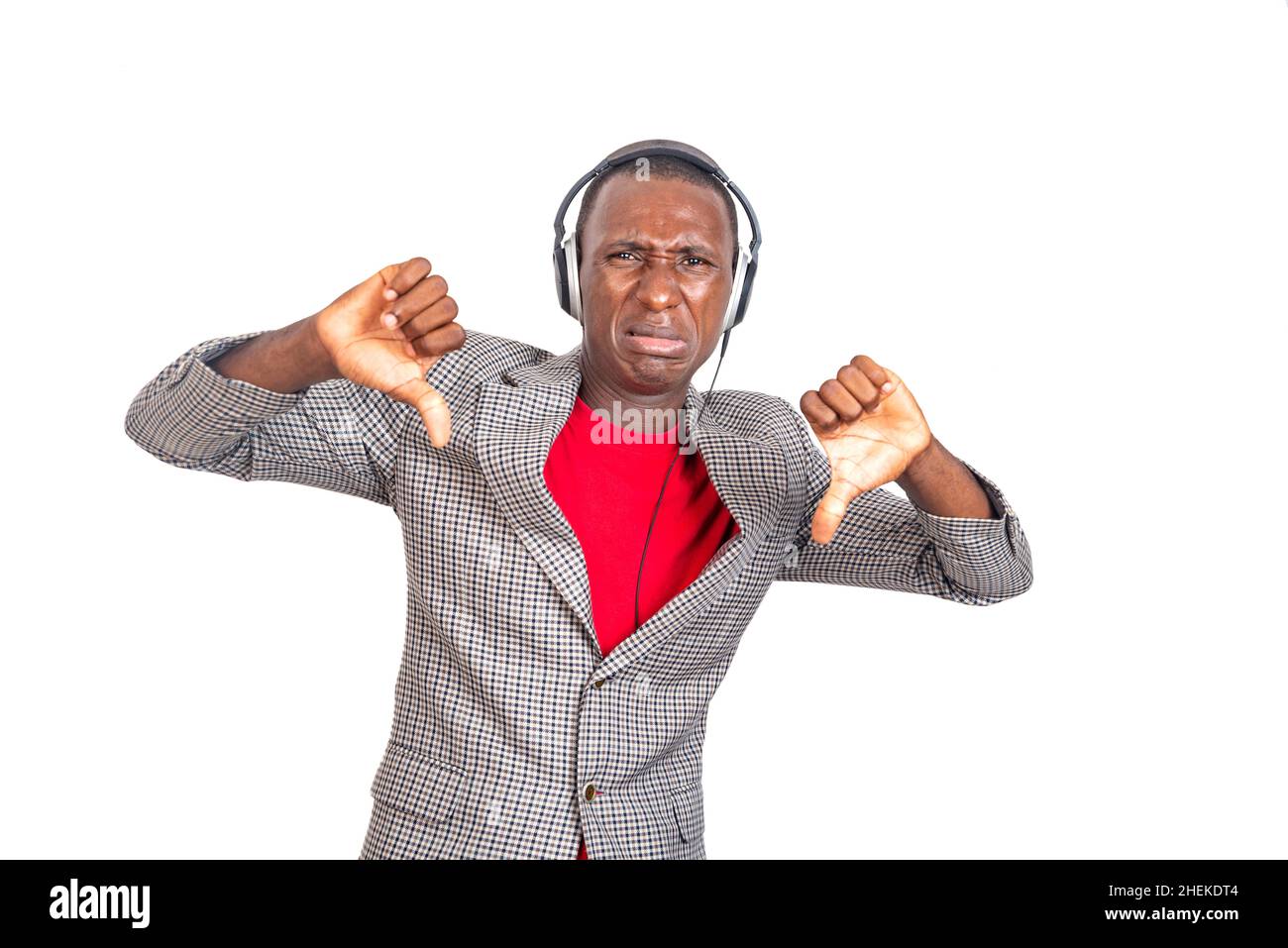 portrait of a handsome angry businessman listening to bad music in ...