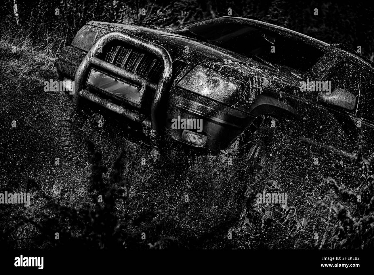 Offroad vehicle coming out of a mud hole hazard. Drag racing car burns ...