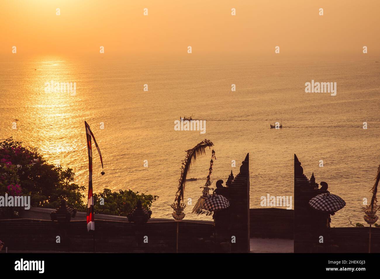 Traditional Balinese boats sailing at the sunset as seen from the Pura ...