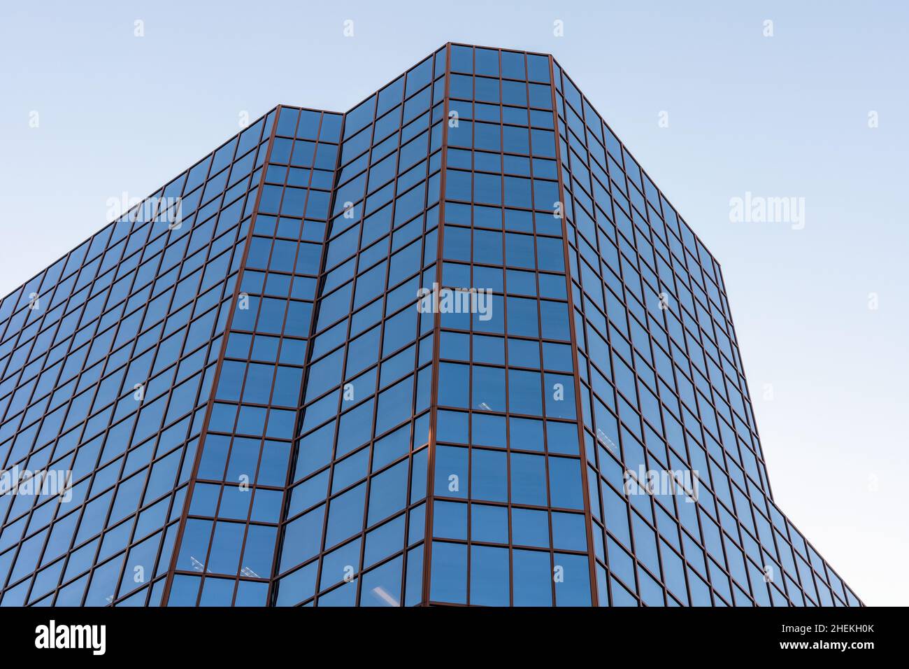 Modern tall glass office building in downtown. Skyscraper against blue ...