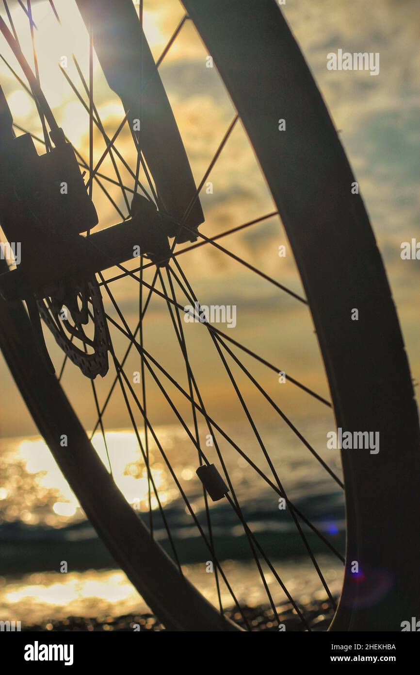 bicycle wheel, cycle wheel on the beach park sunset background Stock ...