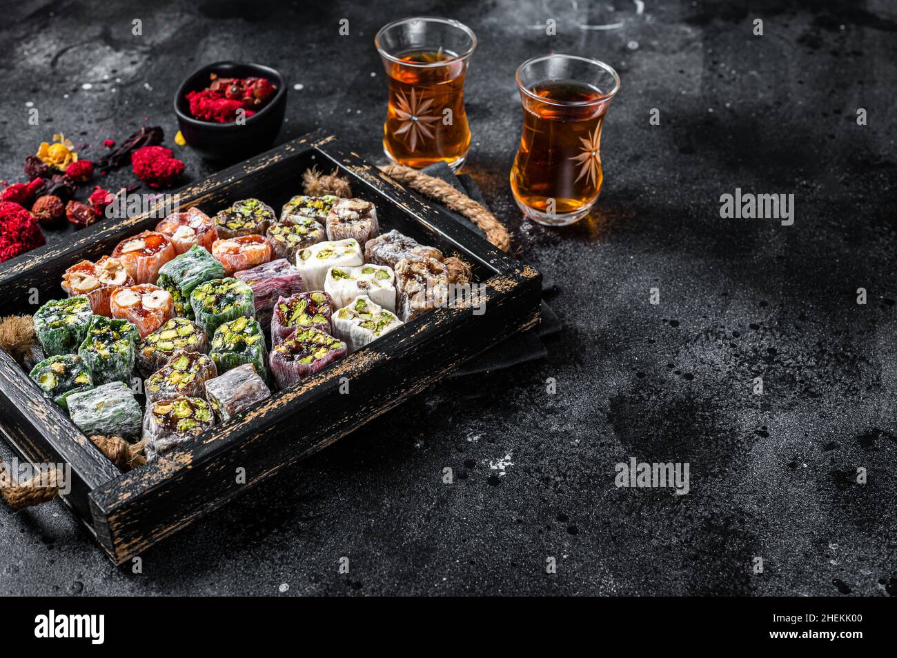 Turkish Delight Lukum, Oriental sweets with nuts and black tea. Black ...