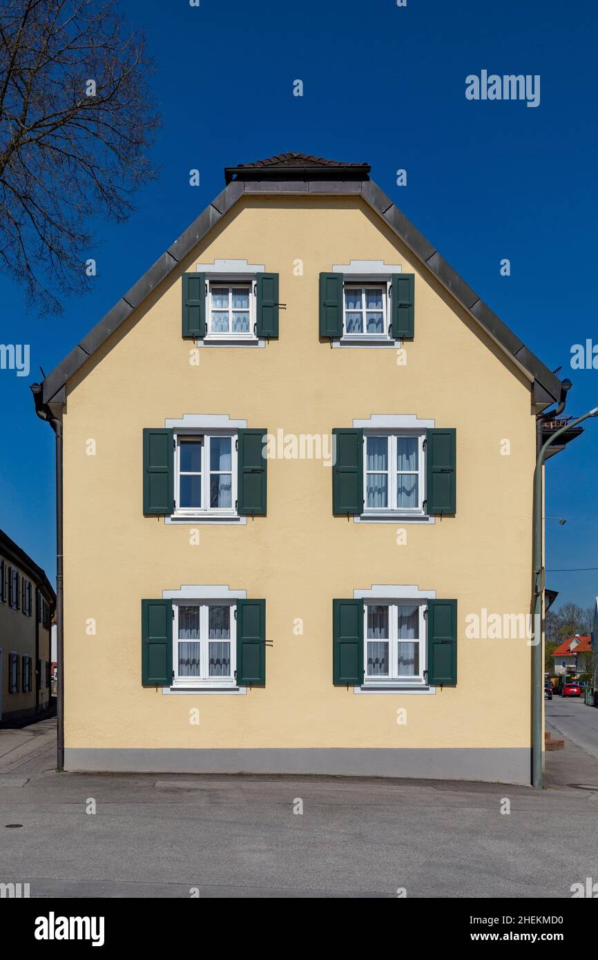 facade of an old generic house with wooden window shutter in green ...
