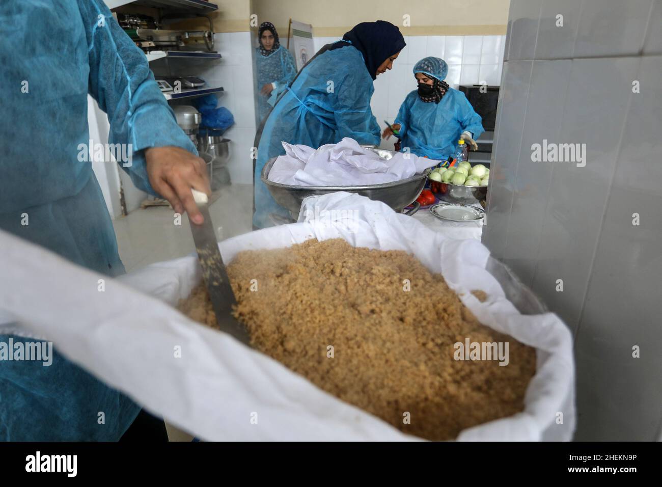 Palestinian women prepare "Maftoul", a traditional couscous dish made ...