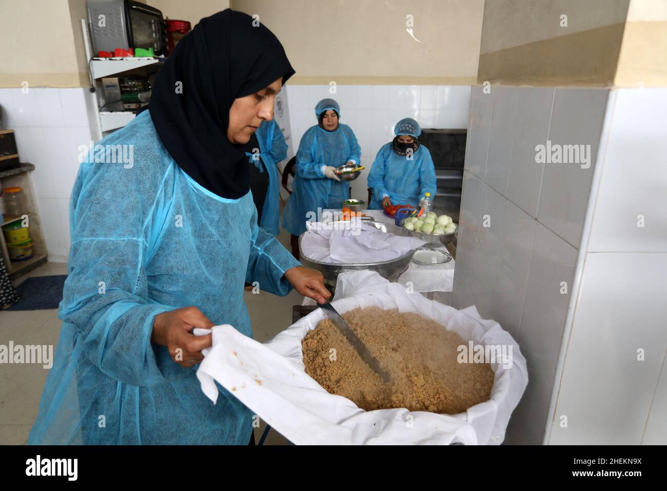 Palestinian women prepare "Maftoul", a traditional couscous dish made ...