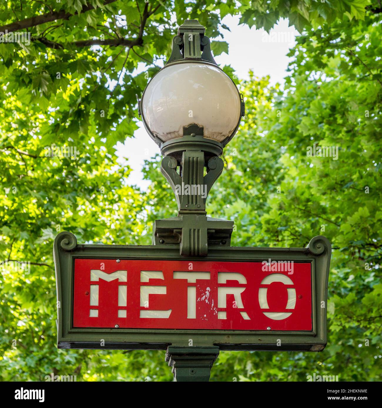 Metro sign in Paris with trees in background Stock Photo - Alamy