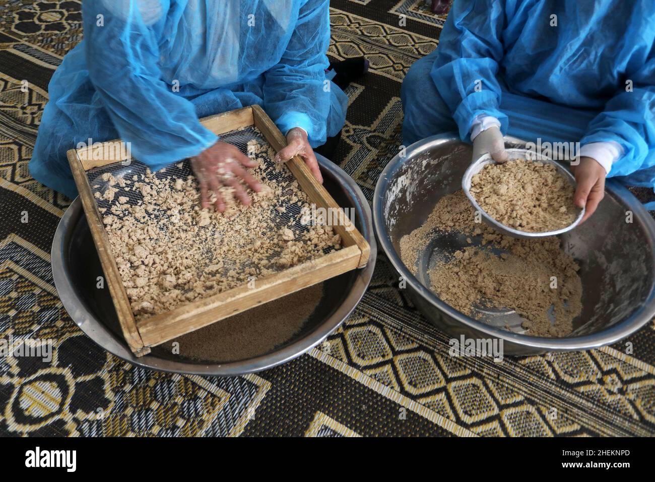 Palestinian women prepare "Maftoul", a traditional couscous dish made ...