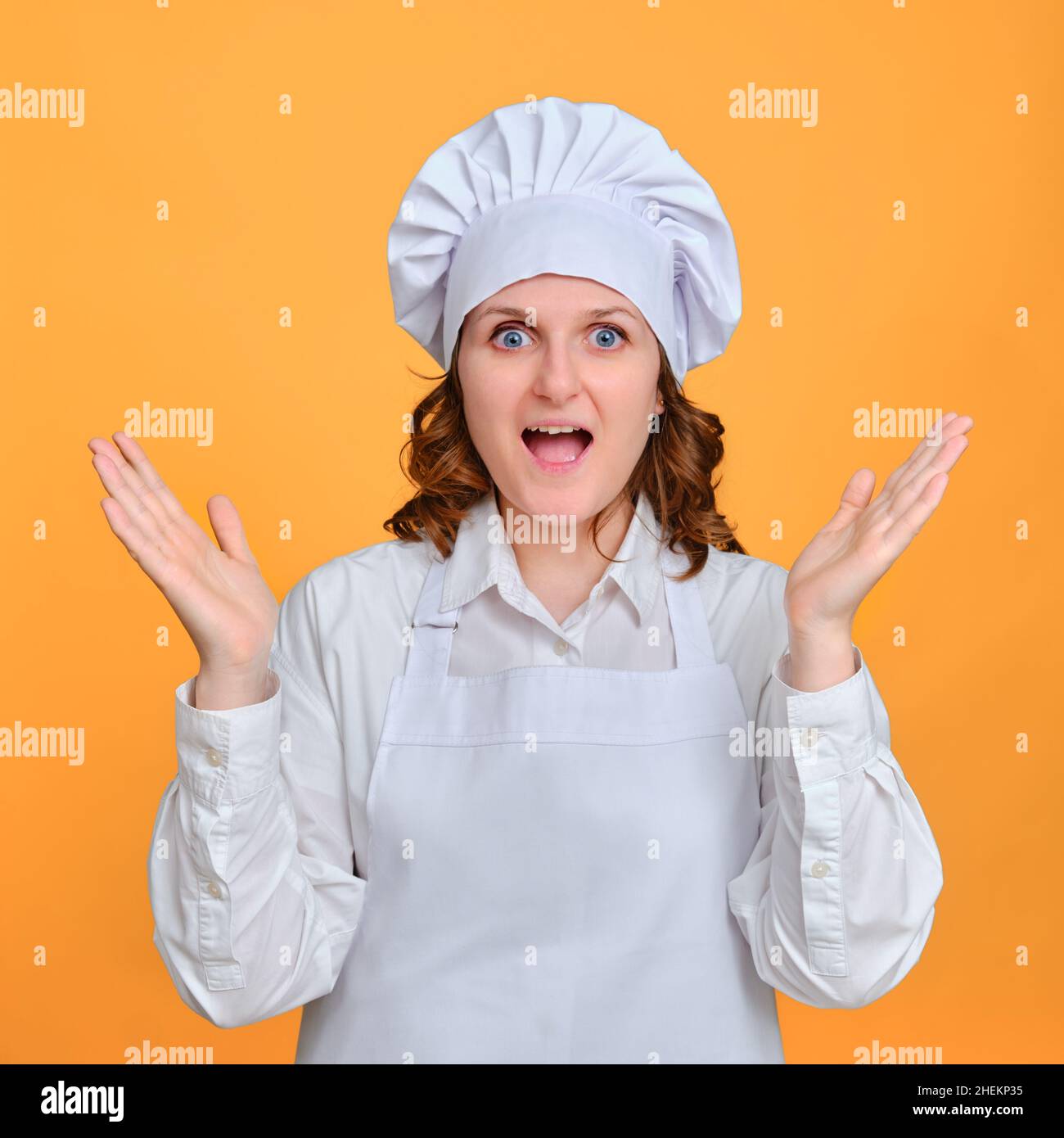 Enthusiastic female chef with a happy smile on her face on a studio ...