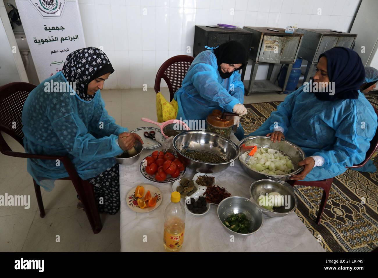 Palestinian women prepare "Maftoul", a traditional couscous dish made ...