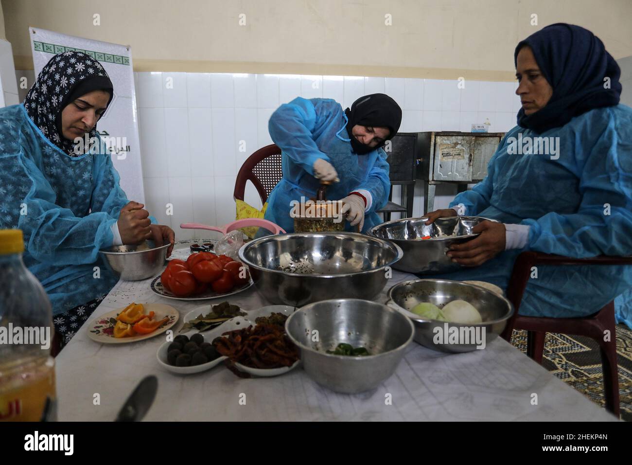 Palestinian women prepare "Maftoul", a traditional couscous dish made ...