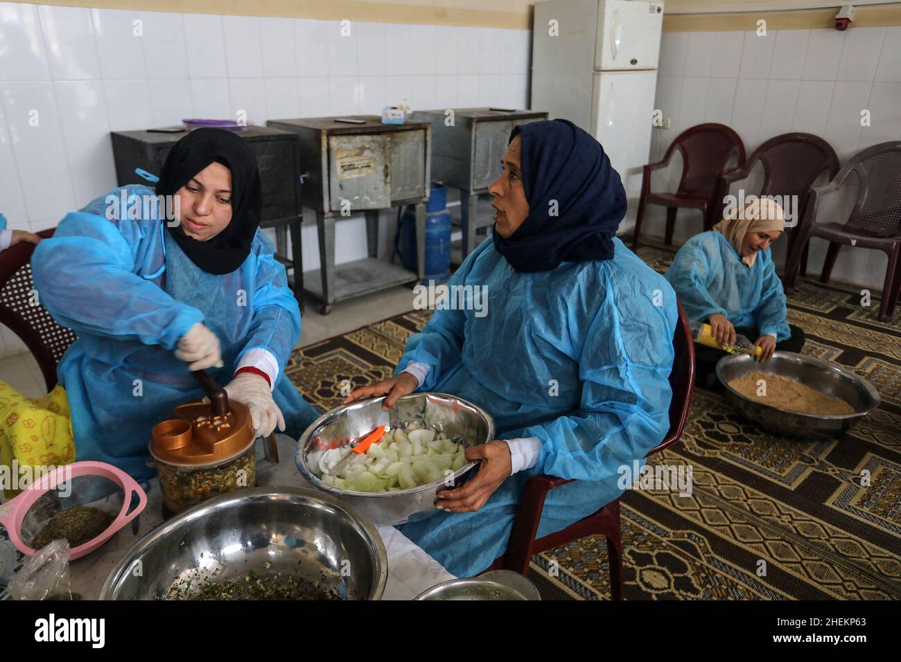 Palestinian women prepare "Maftoul", a traditional couscous dish made ...