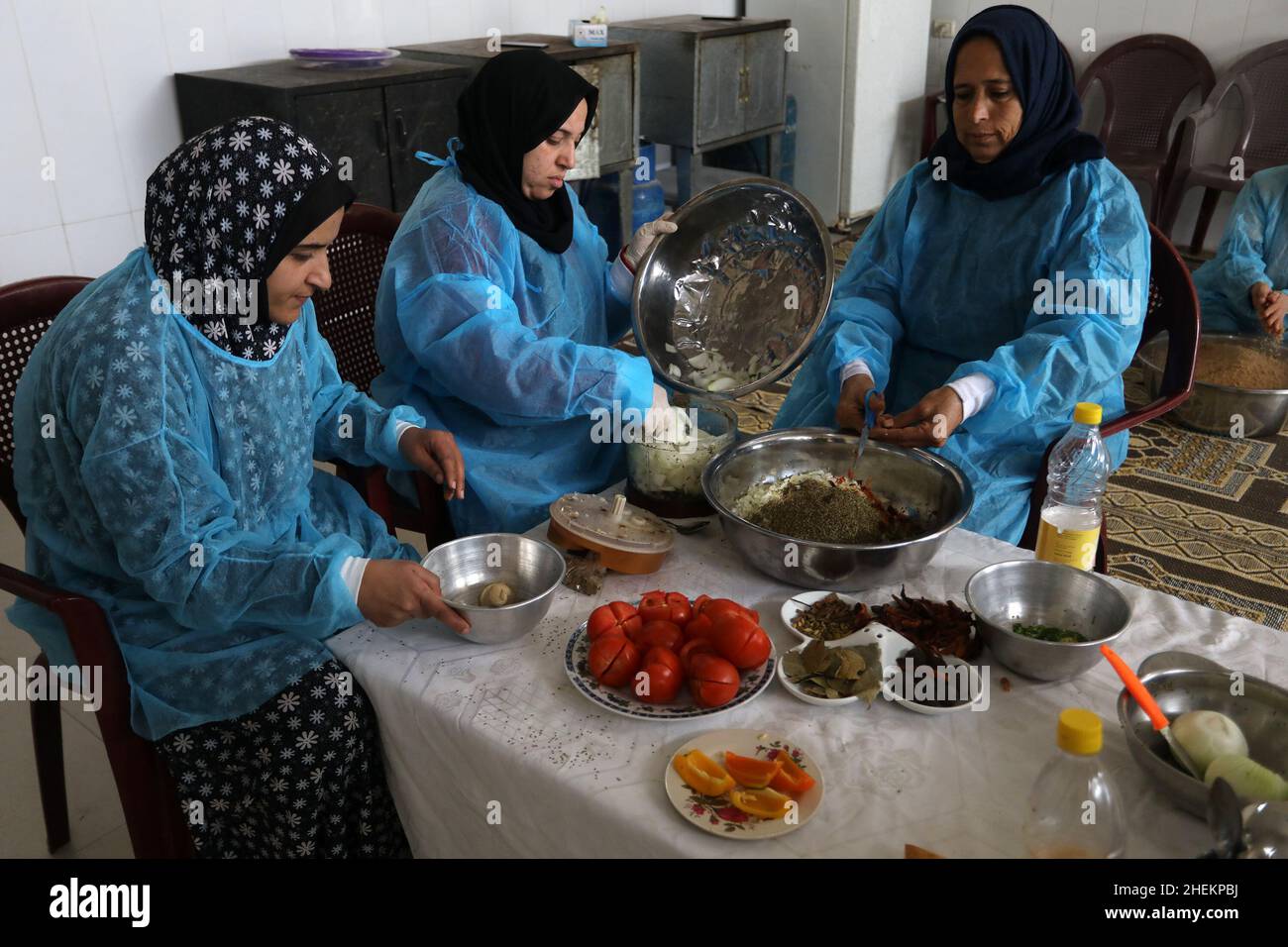 Palestinian women prepare "Maftoul", a traditional couscous dish made ...
