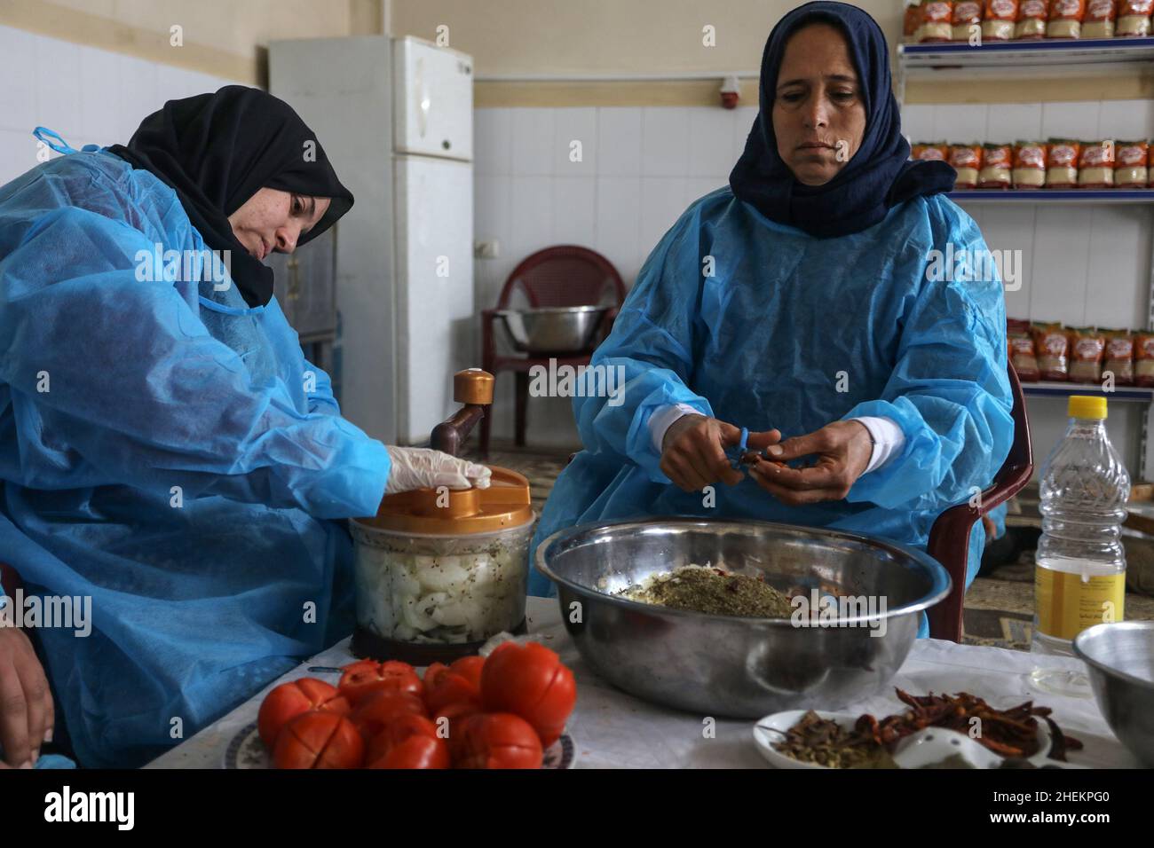 Palestinian women prepare "Maftoul", a traditional couscous dish made ...