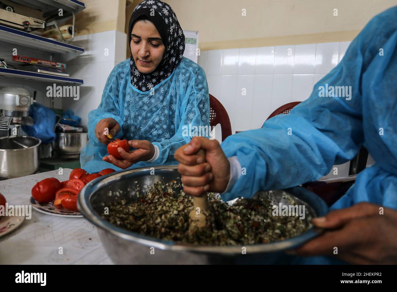 Palestinian women prepare "Maftoul", a traditional couscous dish made ...