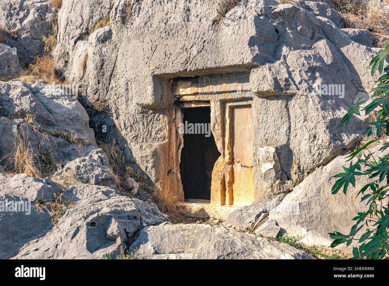 mysterious dark entrance to an ancient rock tomb, carved into the ...