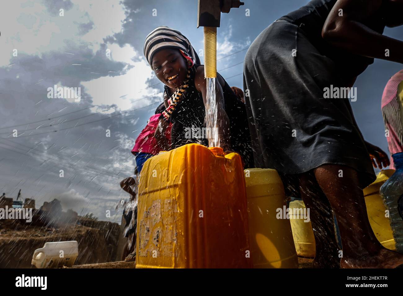 Nairobi, Kenya. 11th Jan, 2022. A woman seen filling up her water ...